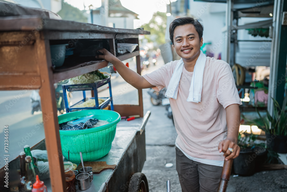 indonesian man standing behind his traditional food cart Stock Photo ...