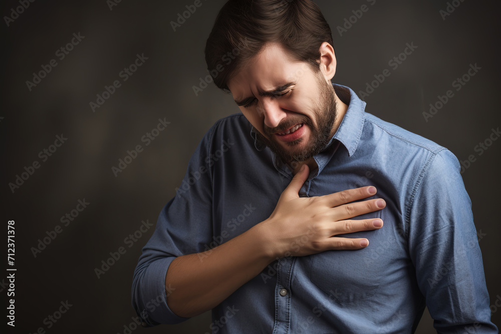 Heart pain, a person grabbing the heart area with his hand, suffering ...
