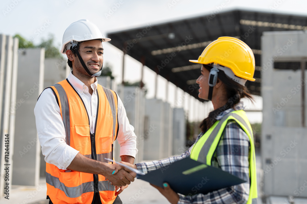 Asian male and female civil engineers wearing vest and helmet safety ...