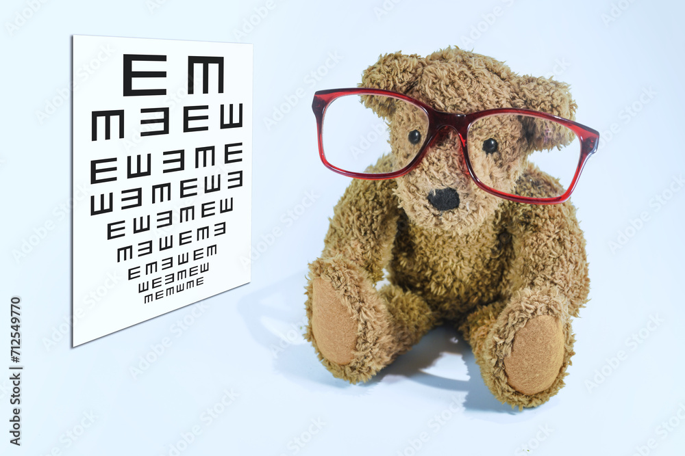 Little teddy bear with big red glasses sitting beside a pediatric ...
