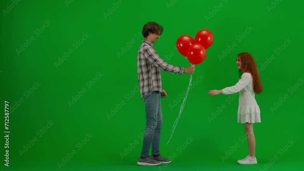Little girl in white dress with red helium balloons on chroma key green ...