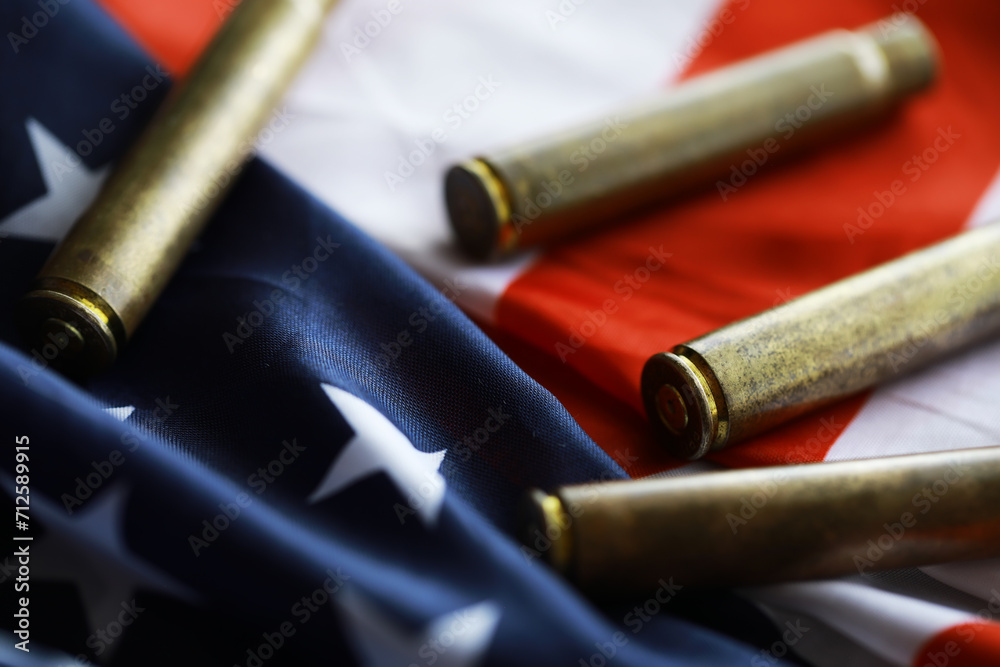 Many bullets cartridges and medals on United States flag. Concept of ...