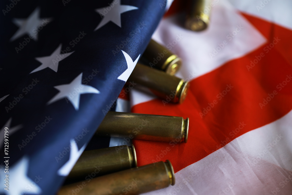Many bullets cartridges and medals on United States flag. Concept of ...