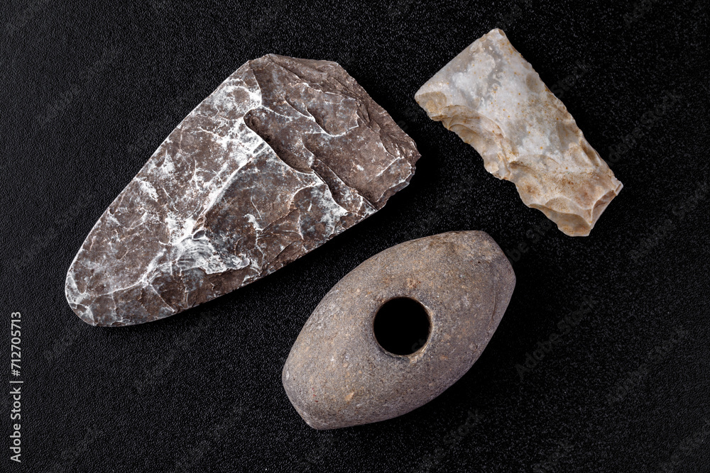 Prehistoric stone axe, isolated on black background.primitive man ...