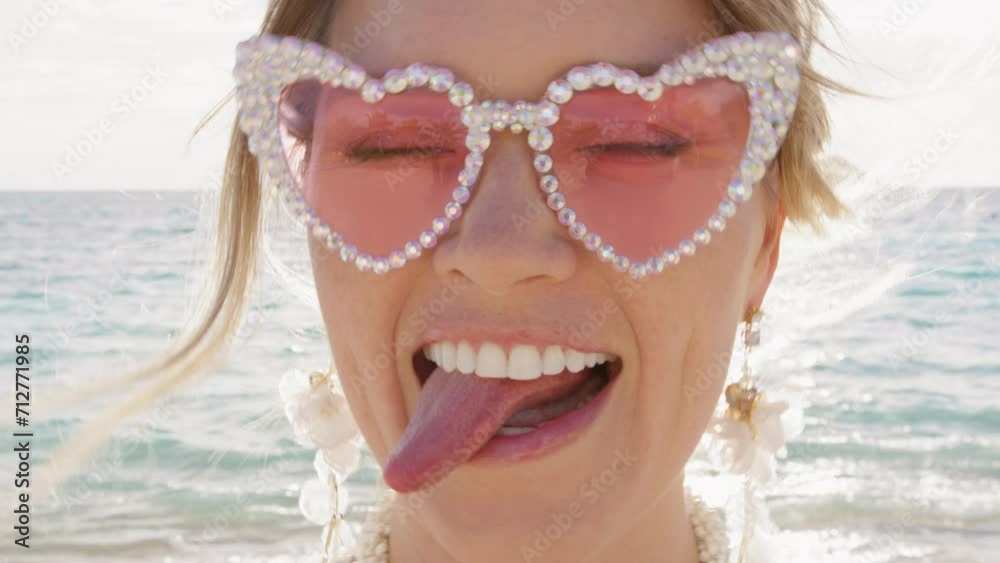Portrait of funny hilarious woman in pink glasses making silly faces ...