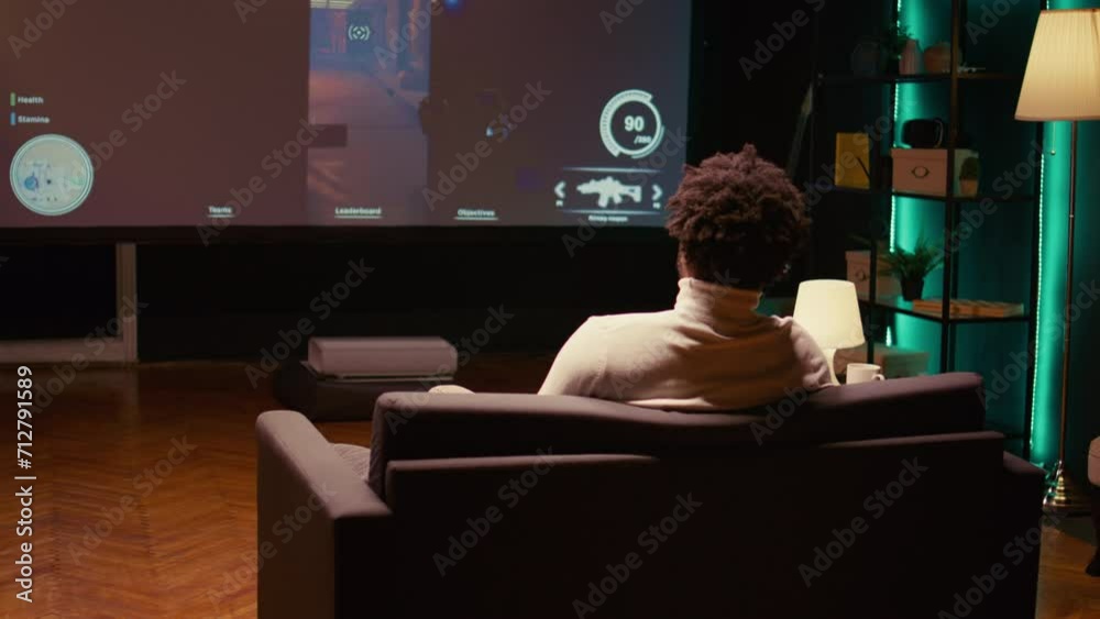 Man playing shooter videogame on TV with gun shooting laser bullets at ...