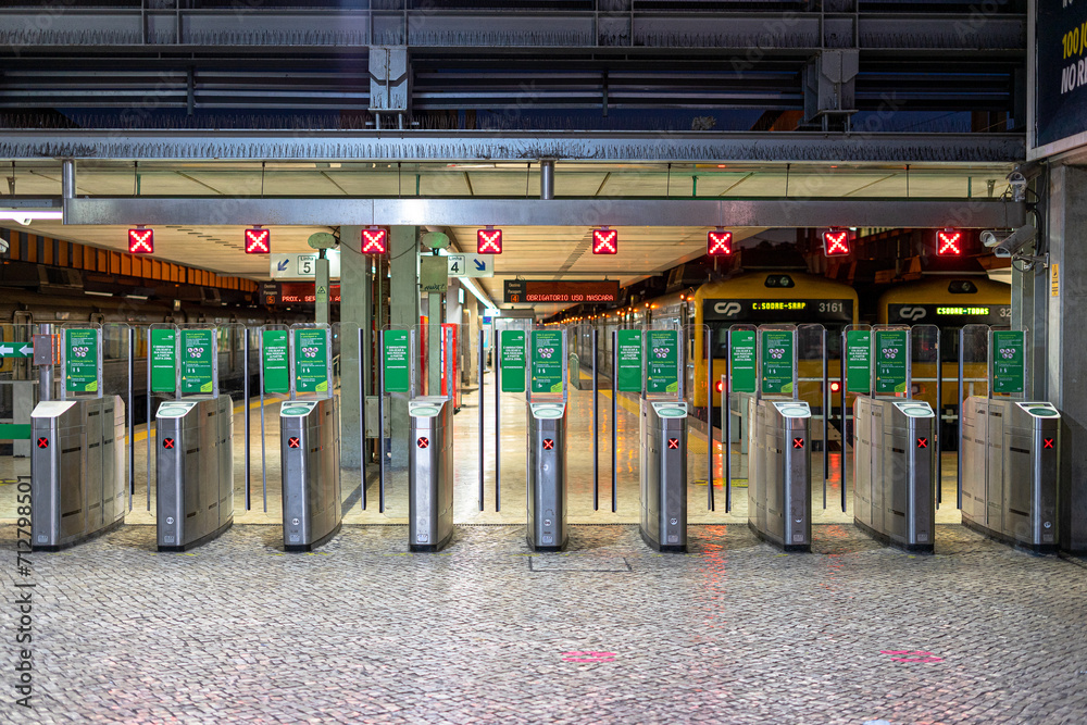 gates, or turnstiles for accessing the train at the railway station ...