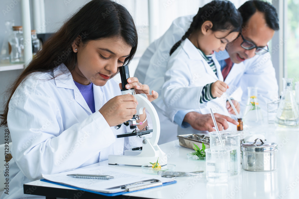 Indian scientist woman student using microscope do an experiment at ...