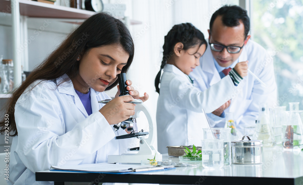 Indian scientist woman student using microscope do an experiment at ...