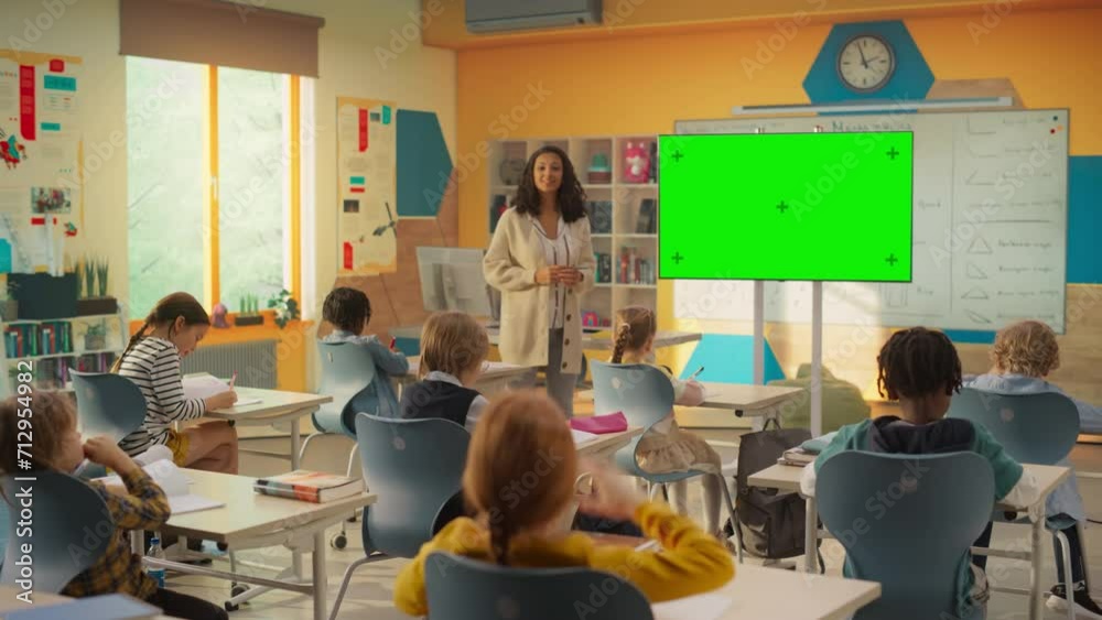 Caring Primary School Teacher Using a TV with Green Screen Display ...