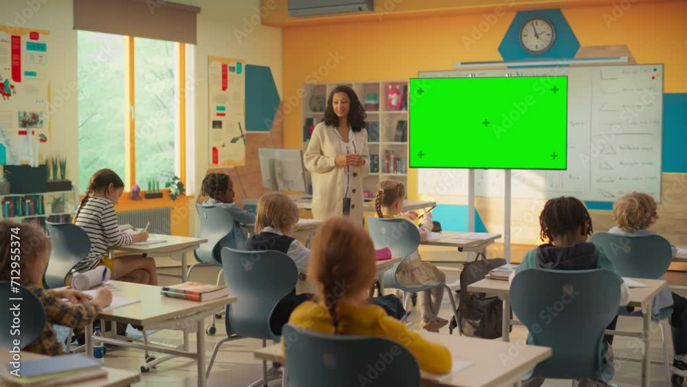Young Teacher Explaining a Class Assignment to Elementary School Kids ...