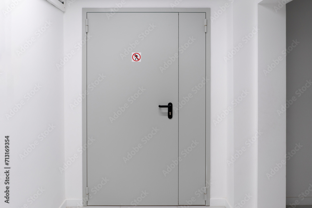 This image shows a closed white door in a contemporary building with a ...