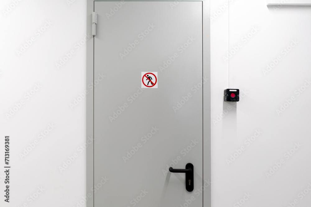 This image shows a closed white door in a contemporary building with a ...
