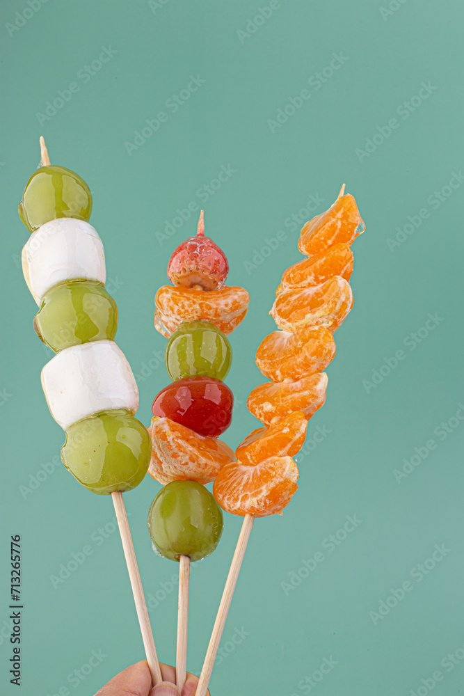 Tanghulu, a fruit skewer Korean snack candy coated with sugar syrup ...