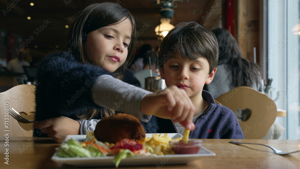 Children eating food at restaurant, siblings - small brother and sister ...