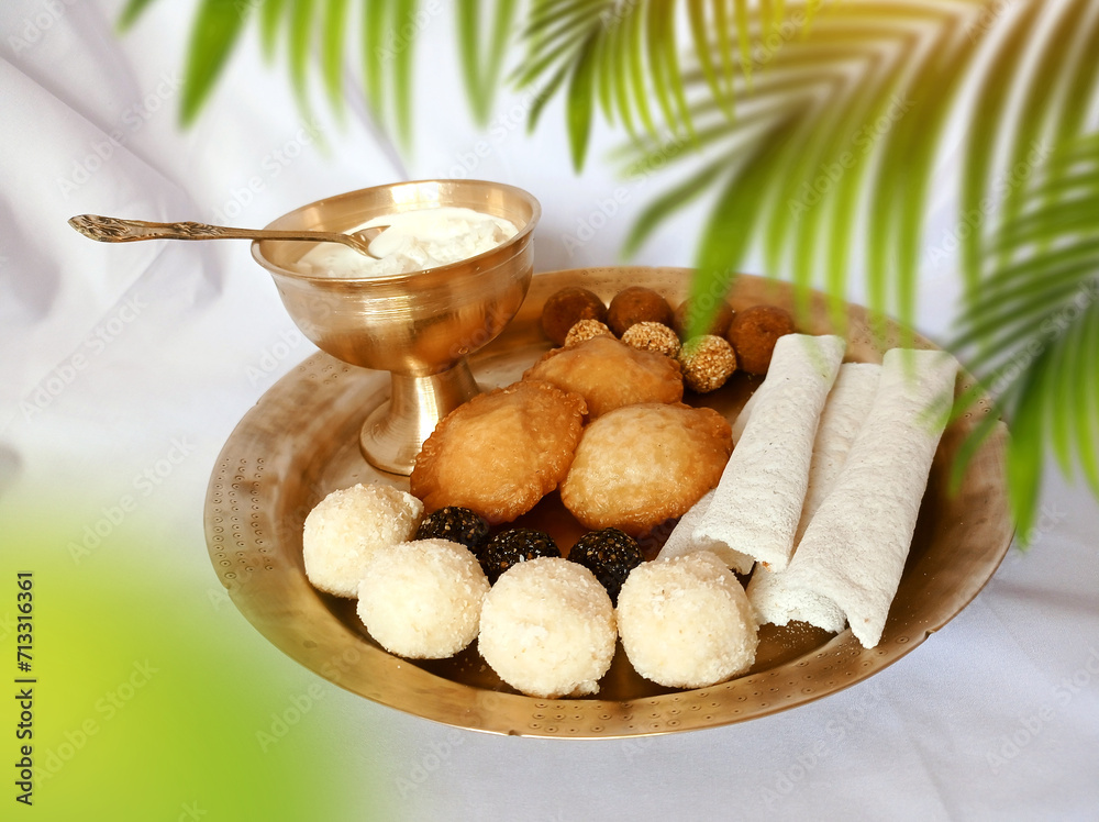 Assamese traditional food items like pitha, laddu, doi sira with ...