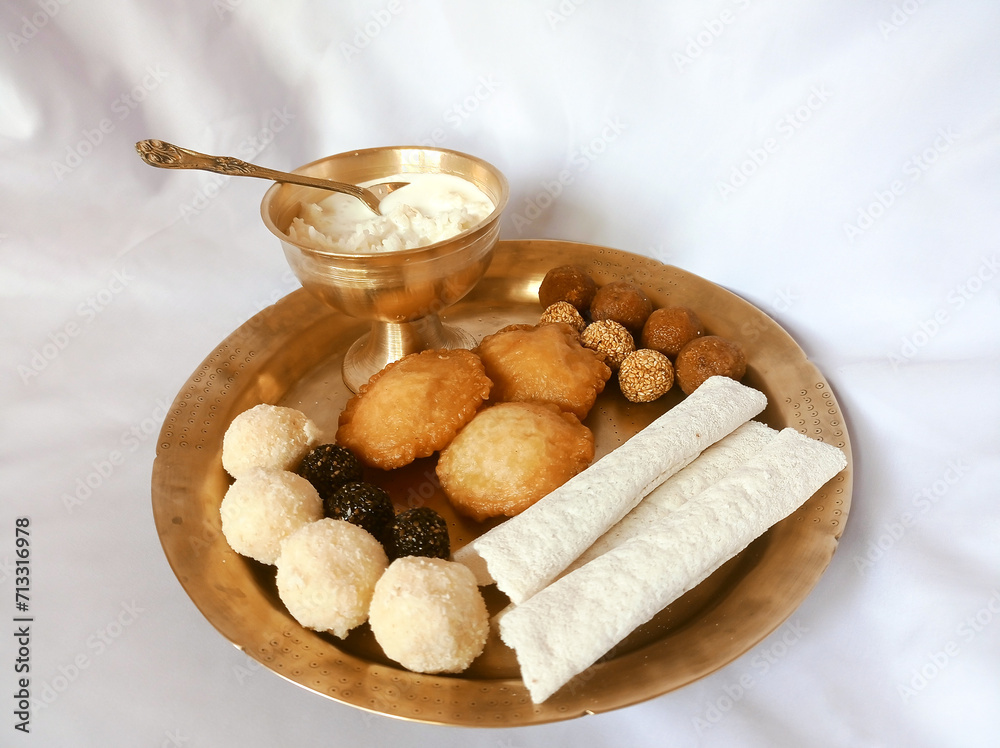Assamese traditional food items like pitha, laddu, doi sira with ...