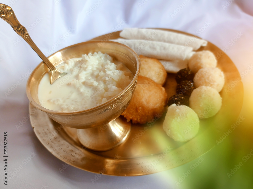 Assamese traditional food items like pitha, laddu, doi sira with ...