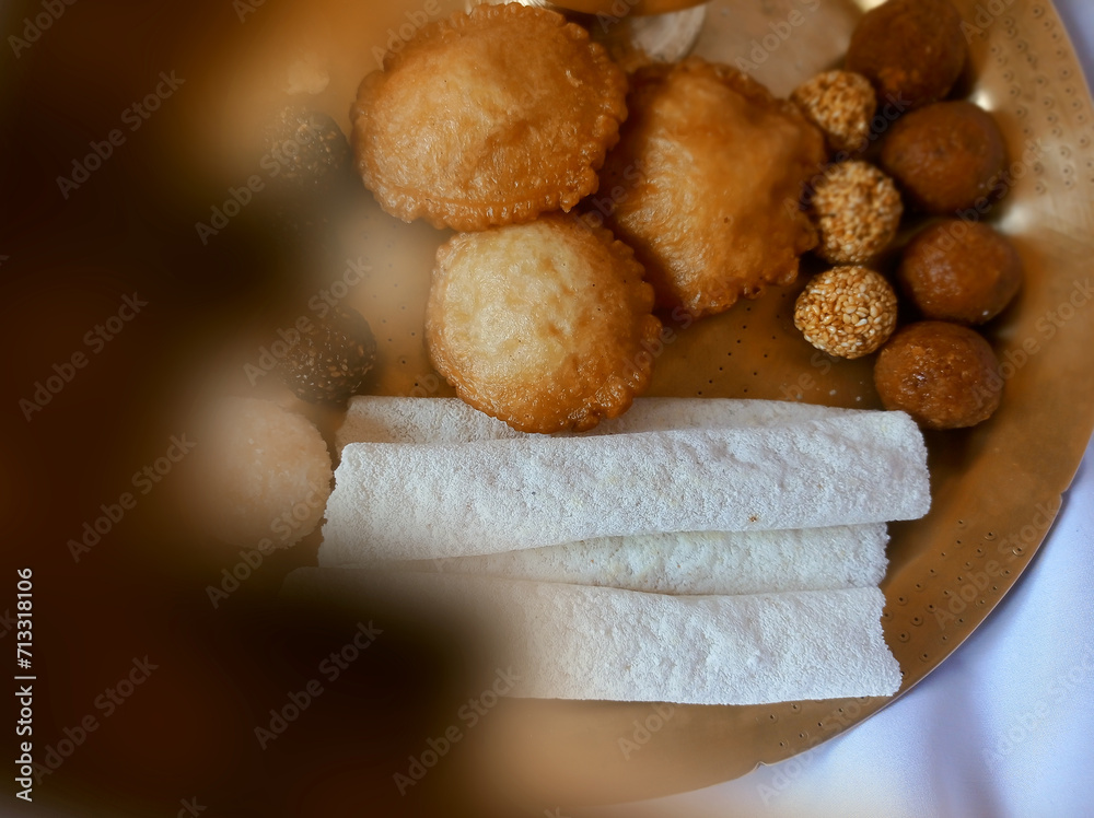 Assamese traditional food items like pitha, laddu, doi sira with ...