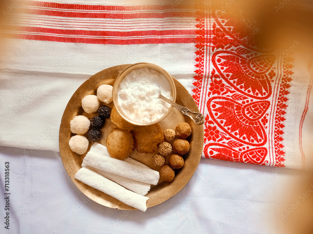 Assamese traditional food items like pitha, laddu, doi sira with ...