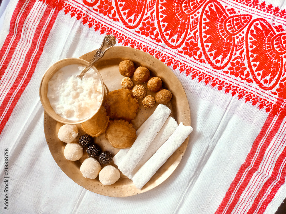 Assamese traditional food items like pitha, laddu, doi sira with ...