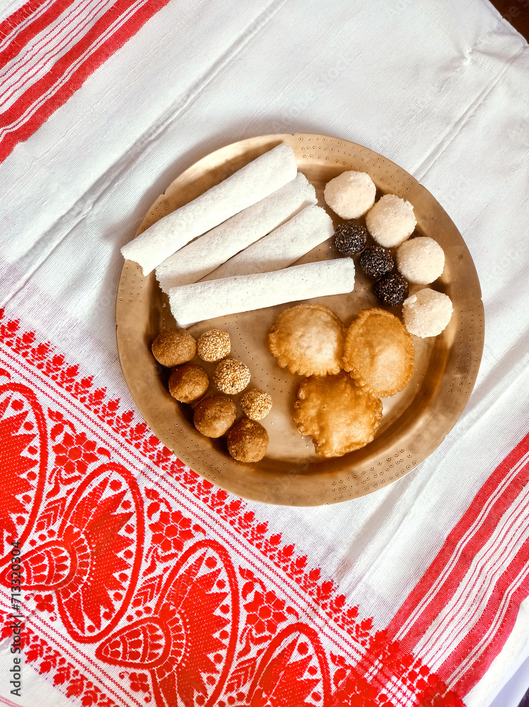 Assamese traditional food items like pitha, laddu, doi sira with ...