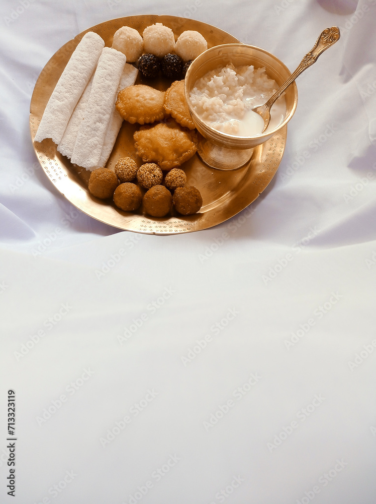 Assamese traditional food items like pitha, laddu, doi sira with ...