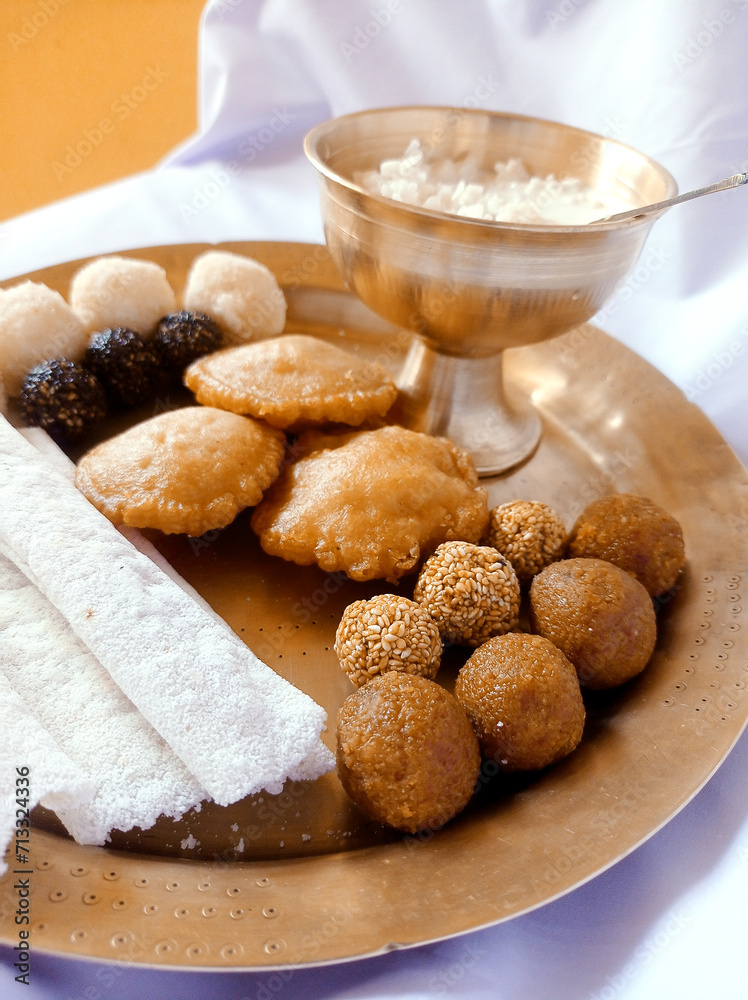 Assamese traditional food items like pitha, laddu, doi sira with ...