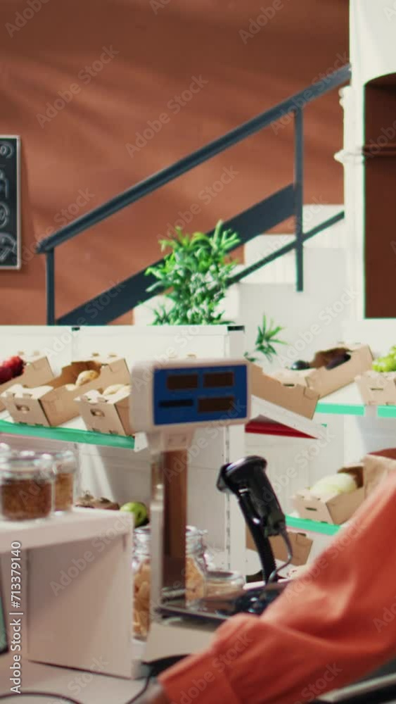 Vertical Video Retailer scanning products and using scale at checkout ...