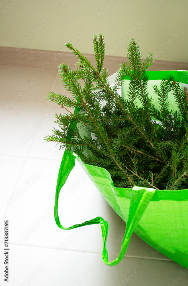 A pile of used Christmas trees in a bag ready for recycling. Christmas ...