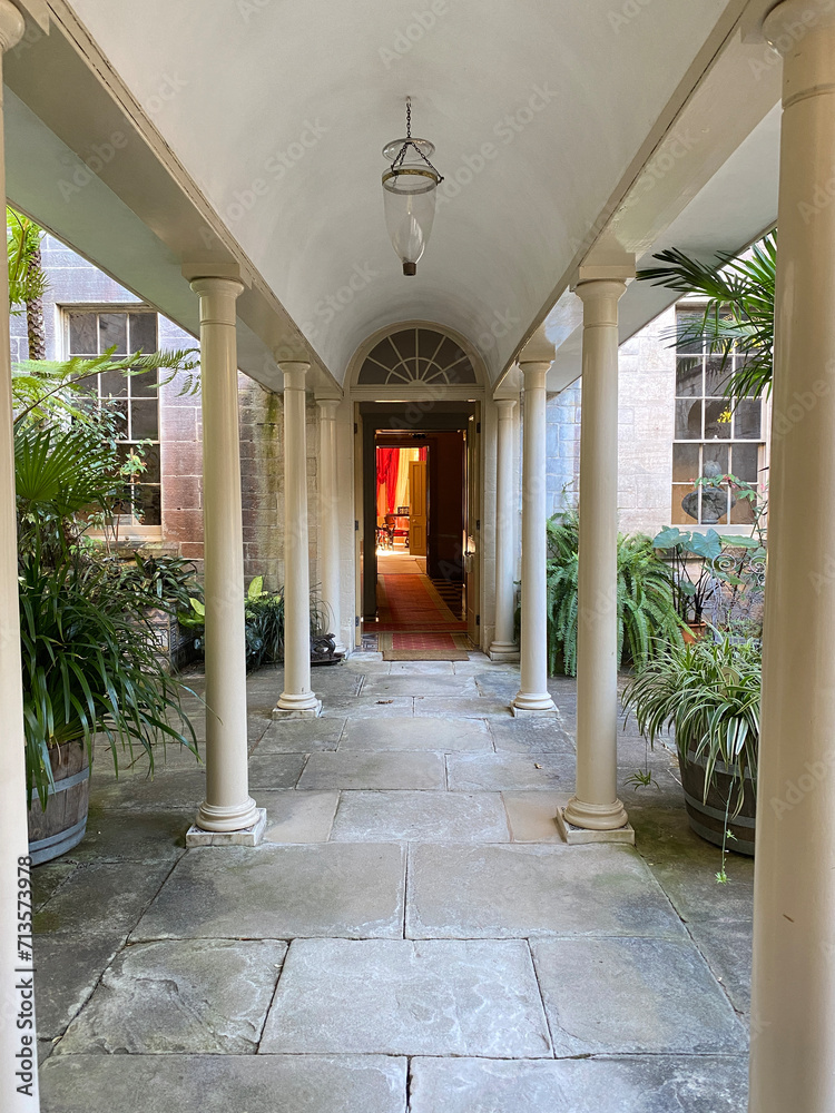 Entrance to a building with a covered roof supported by columns ...