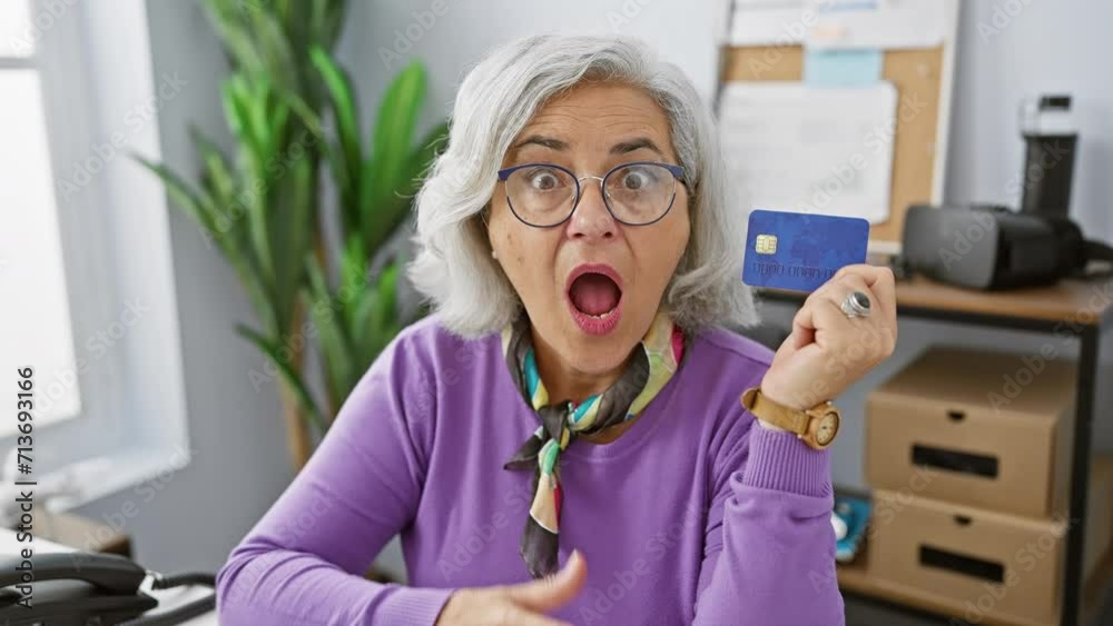 Shocked middle-aged woman, with grey hair and wide-open mouth ...