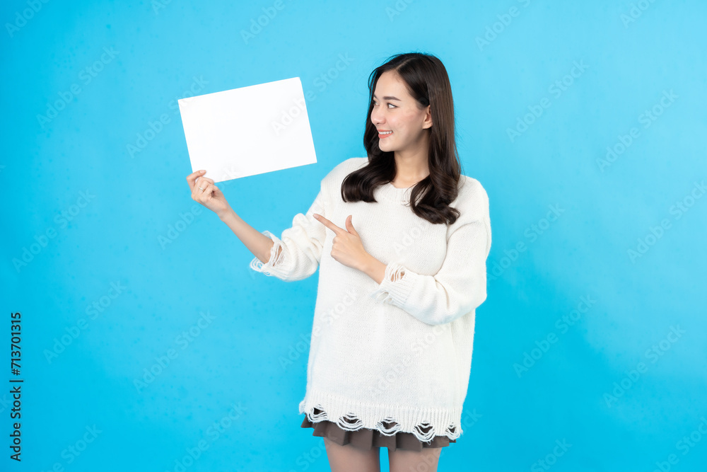 Asian female model with long hair Point and look at the white paper ...