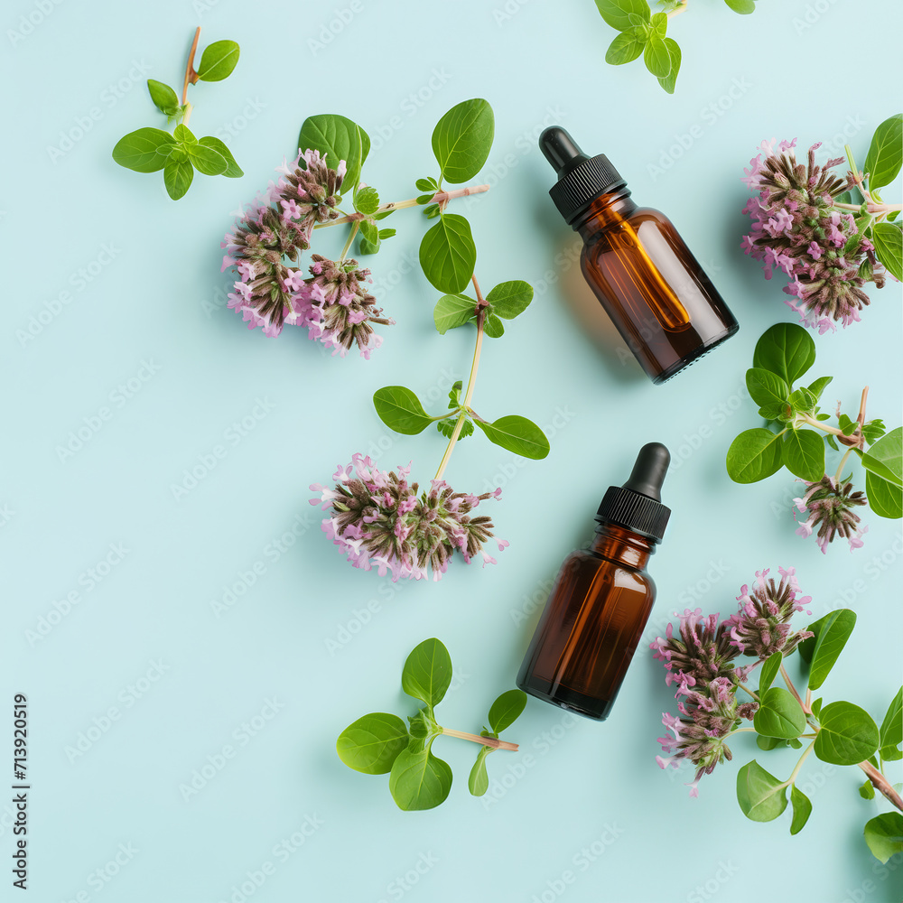 Wild oregano essential oil in a glass bottle surrounded by fresh ...