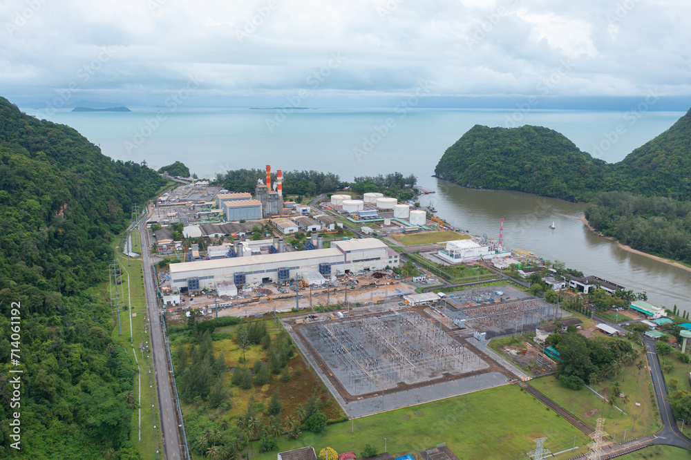 Aerial view of electricity generating, voltage poles with sea b. Power ...
