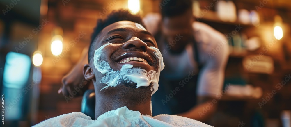 Pictures of a happy young black man getting a professional shave at the ...