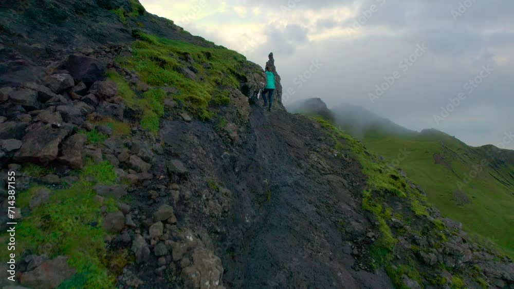 AERIAL: Woman climbs a steep path when a view of amazing Cathedral Rock ...