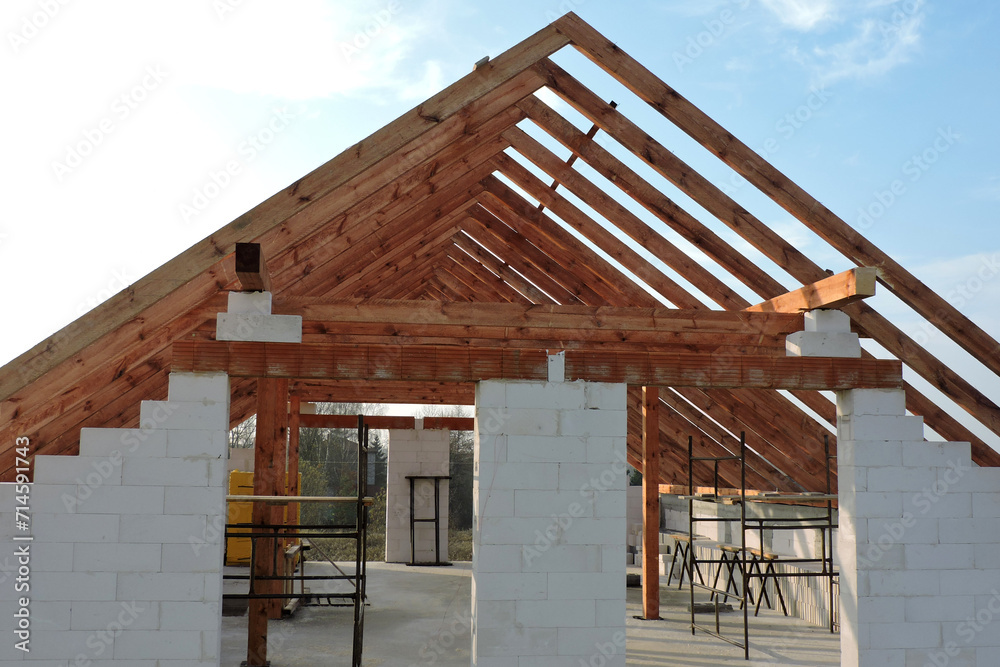 An "A" frame timber roof truss in a house under construction, walls ...