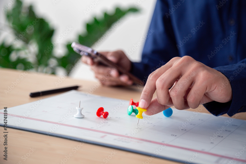 Businessman manages time for effective work. Calendar on table ...