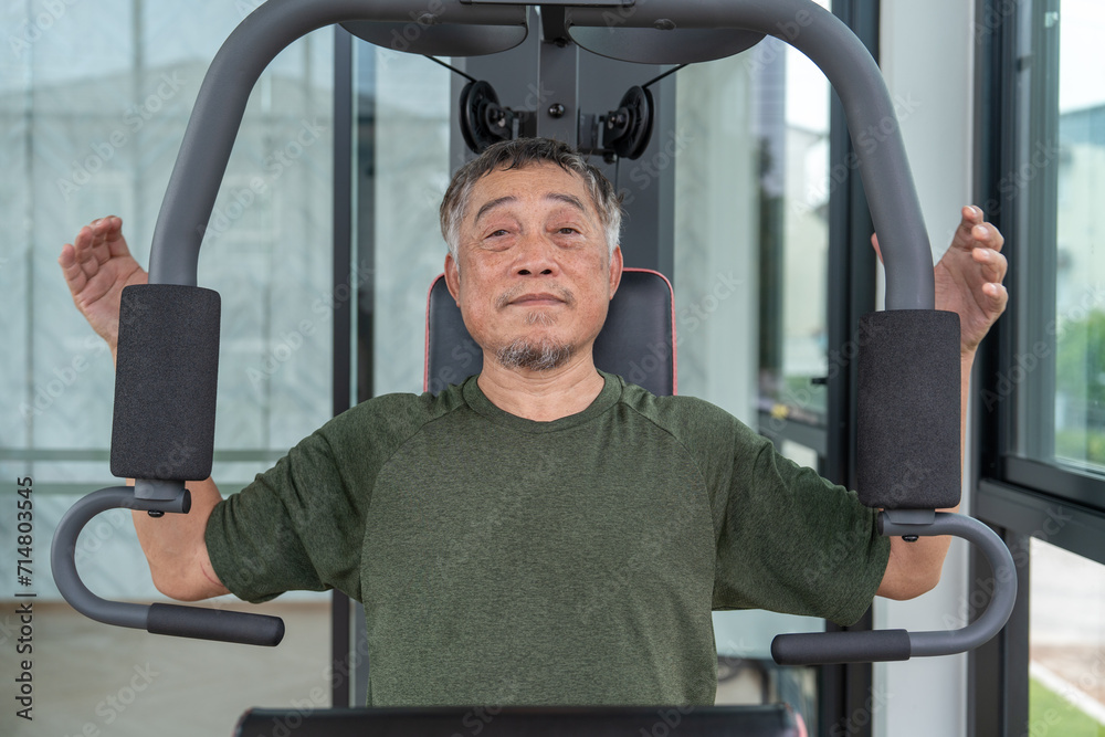 Elderly, Retired or Senior Asian man using pull-down machines to build ...