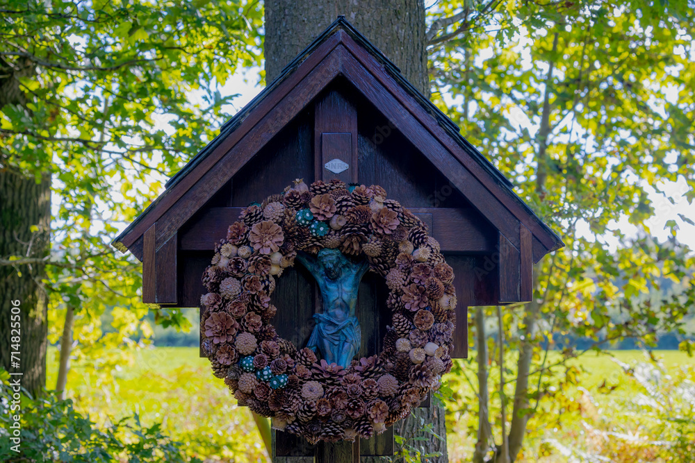 Jesus cross sign hanging on the tree with Autumn pine cone seed wreath ...