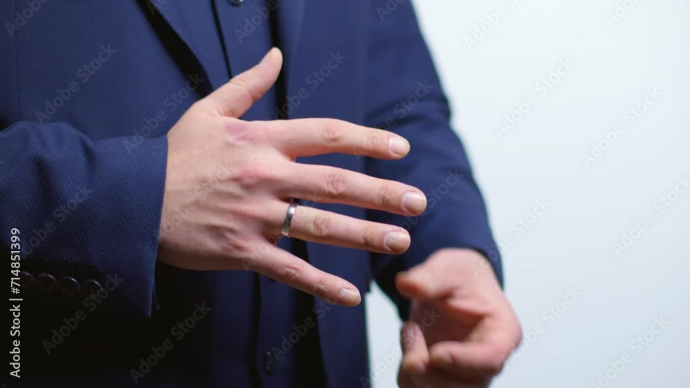 Man putting a ring on the finger of the left hand. A caucasian husband ...