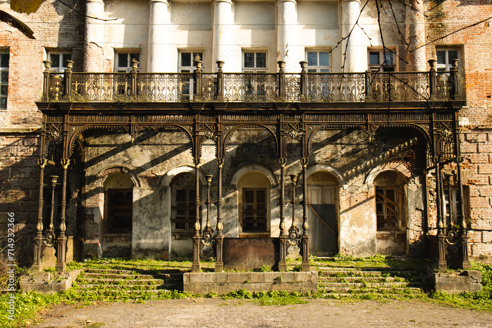 Antique cast-iron balcony. An abandoned manor house decorated with a ...