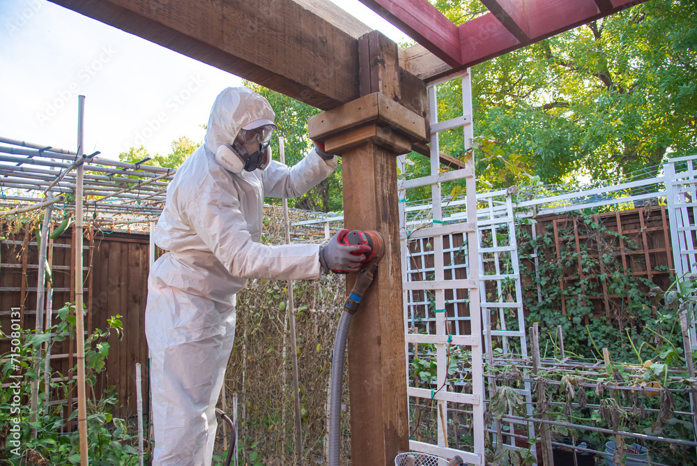 Side view handyman in white hazmat suit full body protection ...