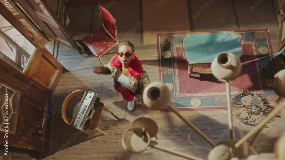 Stylish girl in trendy fur coat and sunglasses performing eccentric ...