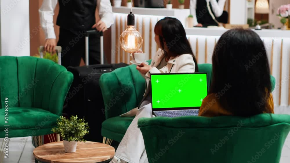 Traveler showing isolated greenscreen template on laptop, sitting in ...