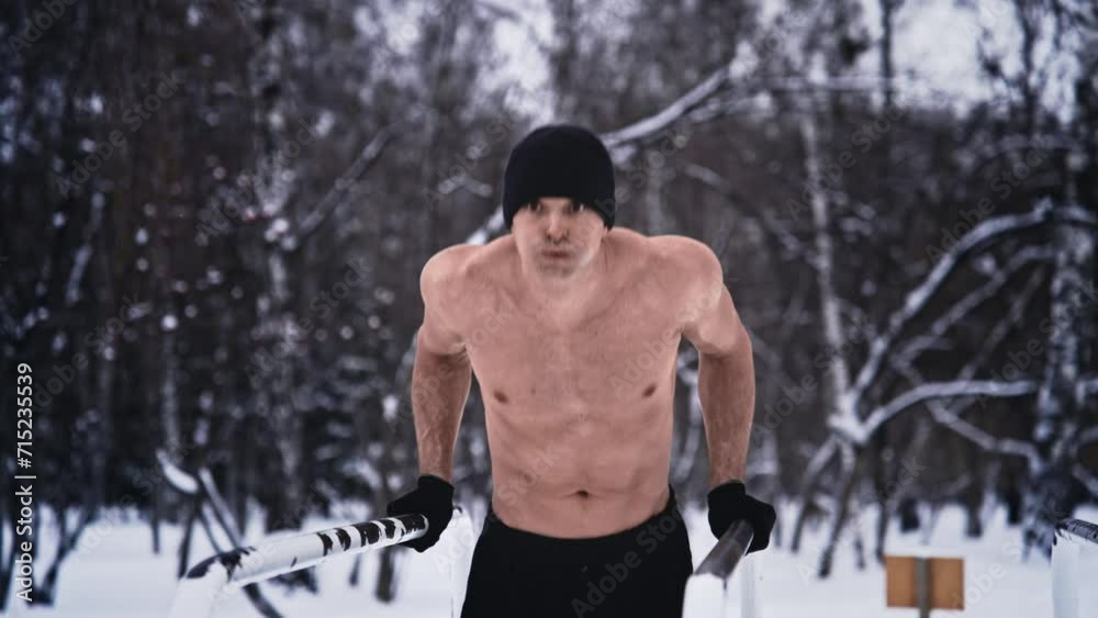 Slim sportsman do arm exercise outdoor gym. Half naked crazy guy ...