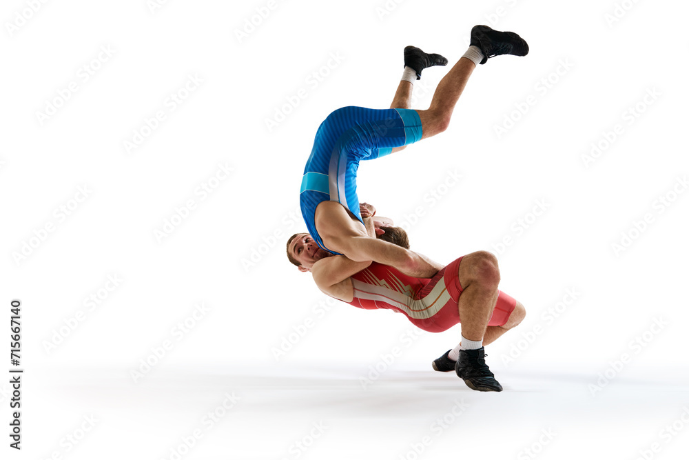 Two athlete man wrestlers fighting in mid-action, one flipping other ...