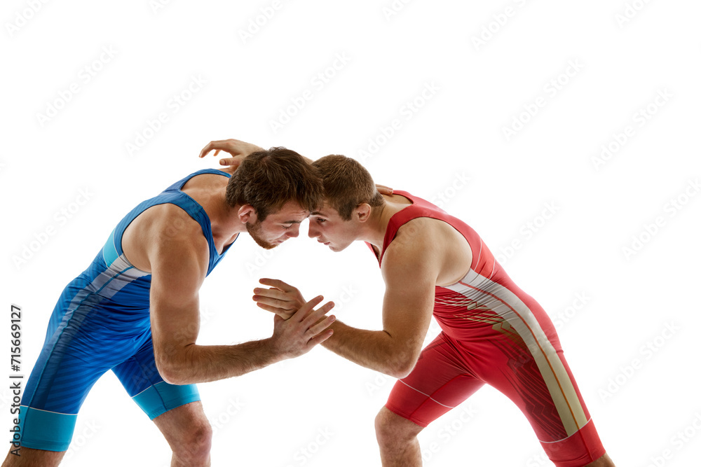 Young skilled wrestlers in blue and red uniform hand wrestling in ...