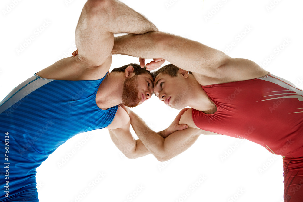 Two young, skilled and professional freestyle wrestlers in red and blue ...